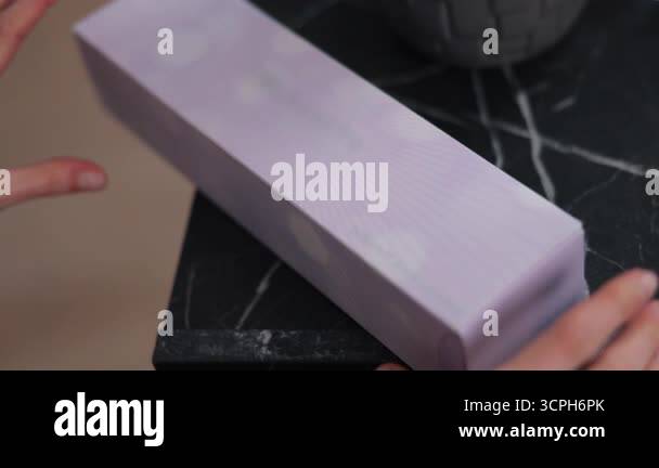 gift box, male hands, marble texture. Detailed view persons hands ...