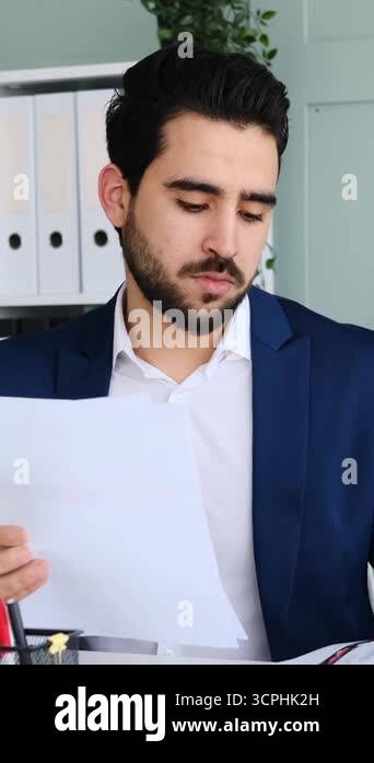 Adult man works in a contemporary office environment with laptop and ...