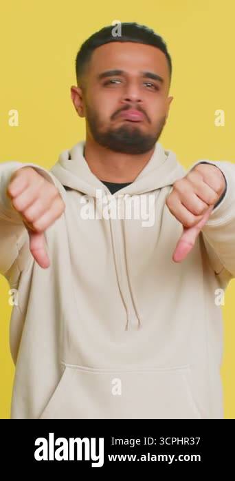 Dislike. Upset unhappy Indian man showing thumbs down sign gesture ...