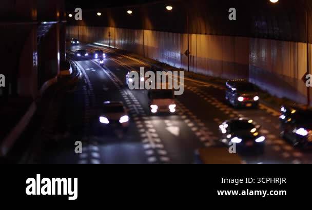 A night cityscape of traffic jam under the city overpass in Tokyo. High ...