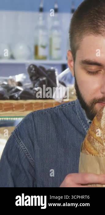 A close-up of a handsome bearded young man, eyes closed in bliss ...