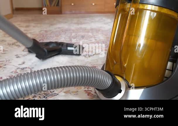 Cleaning the room and carpet with vacuum cleaner. Dust is spinning in ...