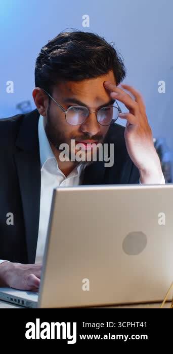 Irritated tired Indian business man while working on laptop, unexpected ...