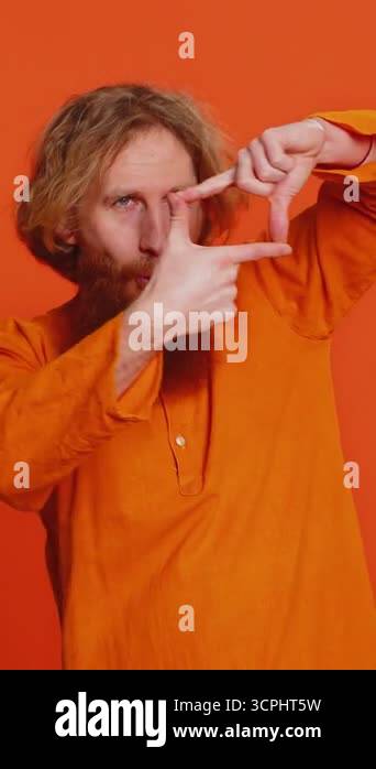 Caucasian man photographer gesturing picture frame with hands, looks ...