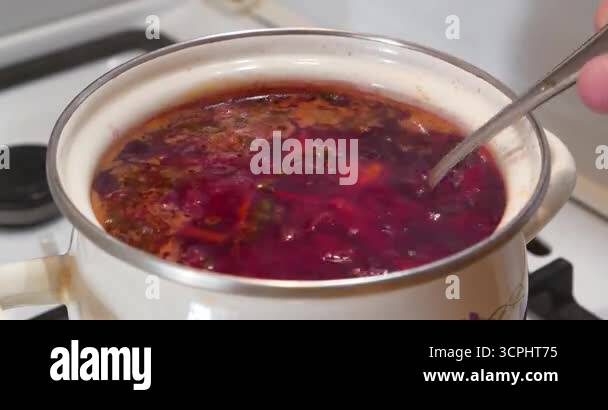 Ukrainian borscht is cooked on stove. National dish of Ukraine. Main first course of Ukrainian ...