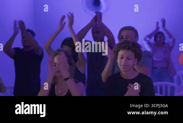 Worshippers clapping and raising hands in spiritual unity during church ...