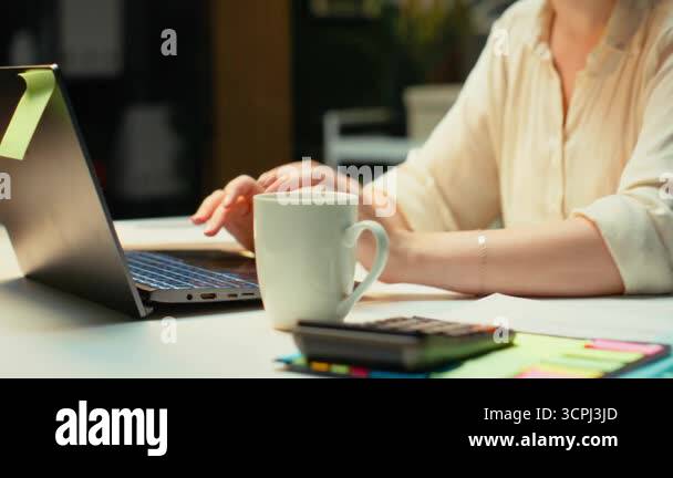 Company manager serving coffee at the office after hours while working ...