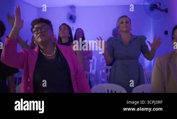 Congregation singing and clapping during evangelical church service in ...