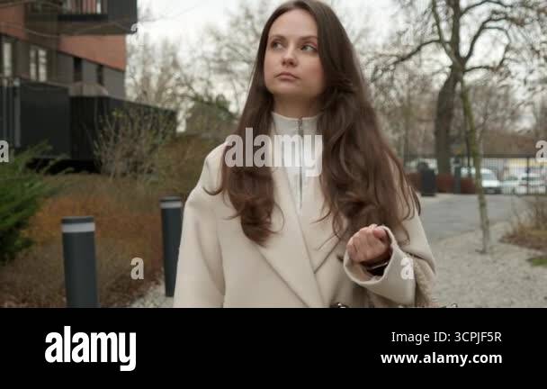 A thoughtful woman walks alone, immersed in her thoughts and personal ...