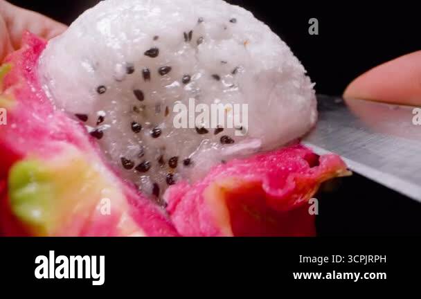 Close Up of White Dragon Fruit With Black Seeds Being Split Open by ...