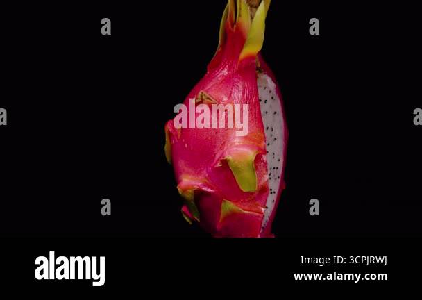 Whole Pink Dragon Fruit Rotating in a Loop While Showing White Flesh with Black Seeds Against ...