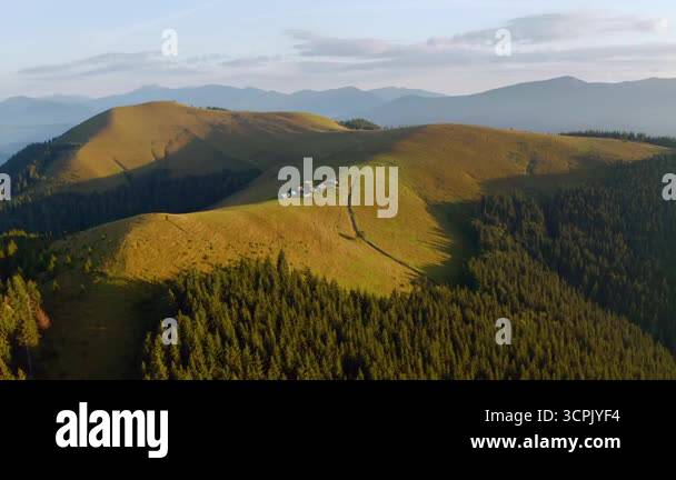 From a bird's eye view alpine mountain settlement on the green hills ...