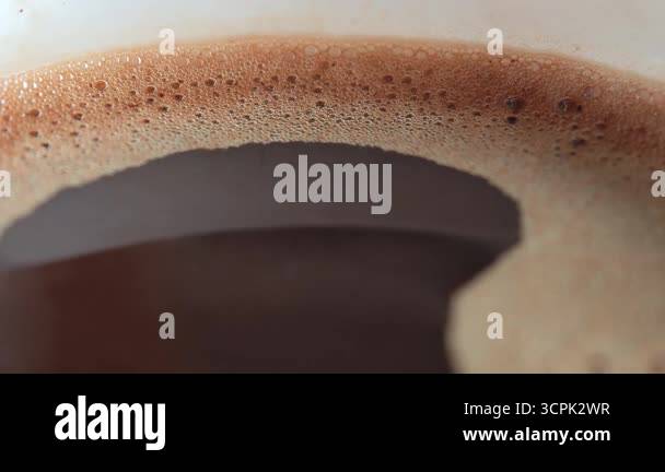 Delicate coffee foam pattern creating intricate swirling textures ...