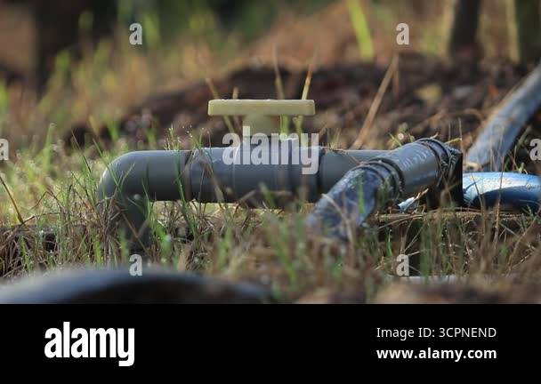 A close-up video of a water valve and plastic pipe system for ...