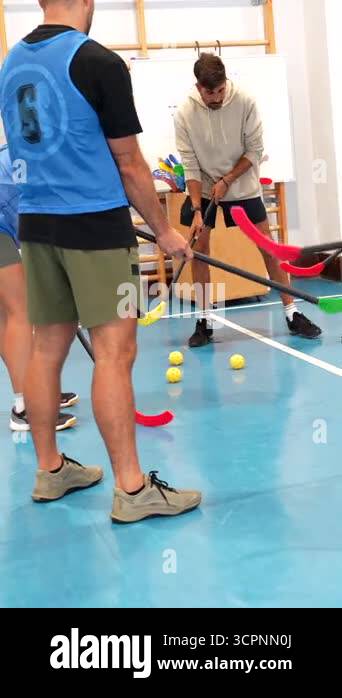 Professional hockey players training collaboratively in gym, developing skills through ...