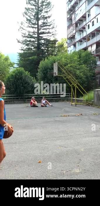 Basketball players practicing skills on urban outdoor court, honing ...