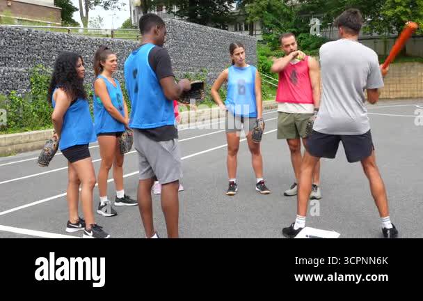 Professional baseball coach guiding players through proper batting ...