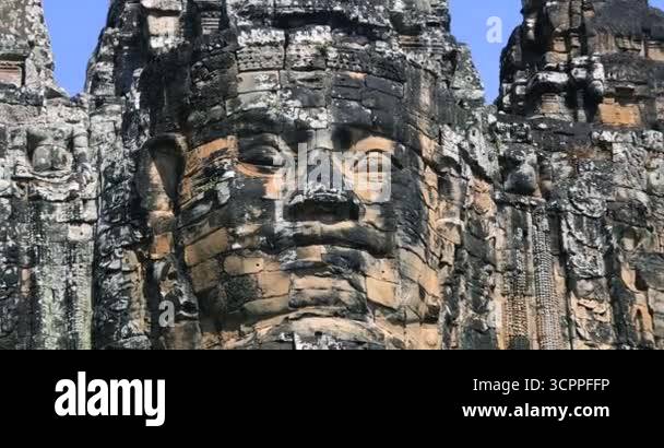 Historic famous Smile buddha face Statue of Bayon Temple in Angkor Thom ...
