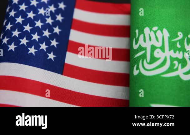 A close up footage of the USA national flag together with the Saudi ...