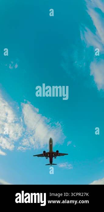 Airliner flying in blue sky with clouds surrounding and engines ...