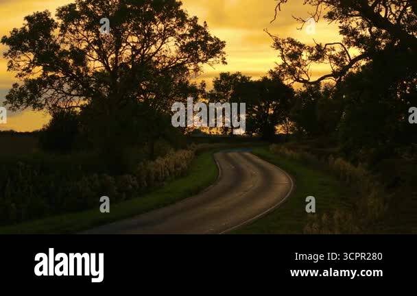 Car driving on countryside road during sunset. Road trip, car traveling ...