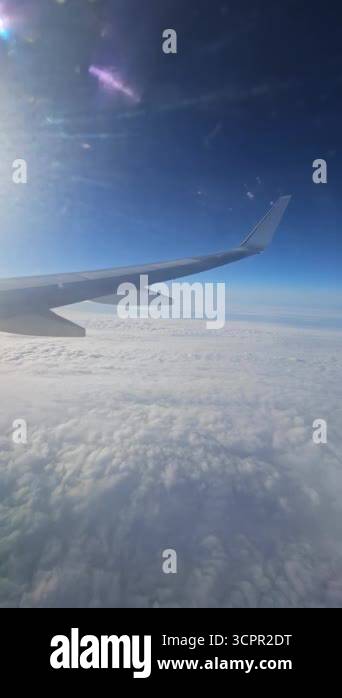 Jet flying above thick clouds reflecting morning sunlight. Aircraft ...