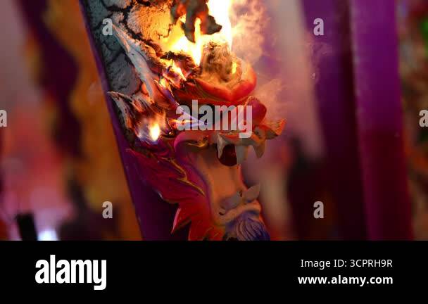 A dragon head is lit on fire. The dragon is on a purple object Stock ...