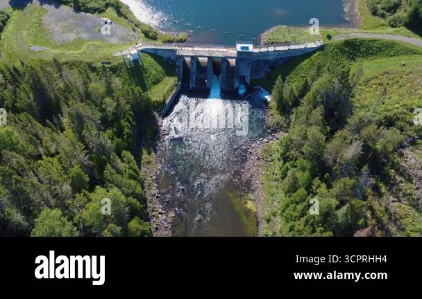 Static aerial view of the Mitis Dam outlet, which creates eddies in its ...