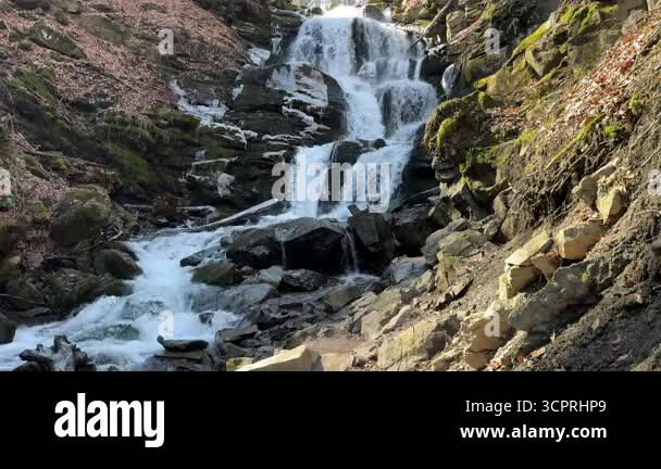 stones and boulders washed by the river current, a small waterfall in ...