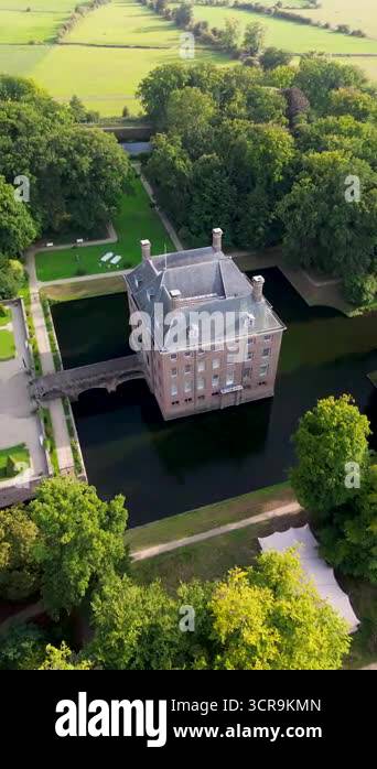 An aerial view of a historic brick castle with a tiled roof, surrounded ...