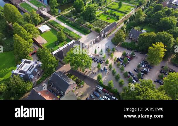 An aerial view of a historic brick castle with a tiled roof, surrounded ...