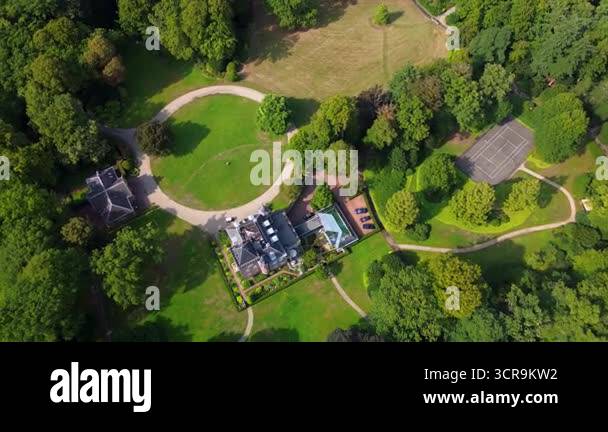 Aerial view of a grand estate with a sprawling mansion, landscaped ...