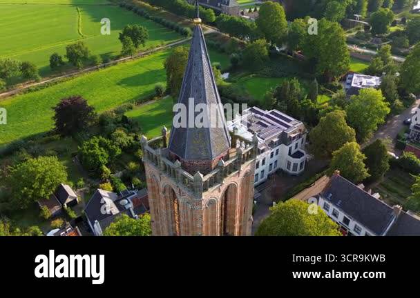 Aerial view of a tall redandbeige brick church tower with a steep slate ...