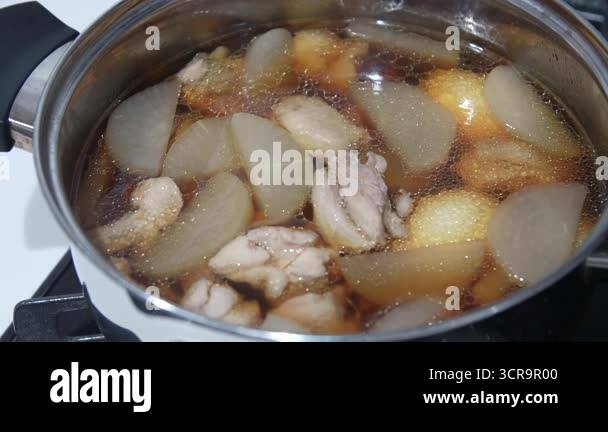 Making radish and chicken stew Stock Video Footage - Alamy