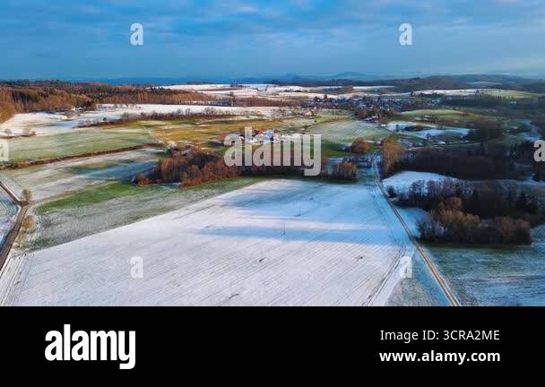 Snow-covered agricultural unplanted fields and bald winter trees on the ...