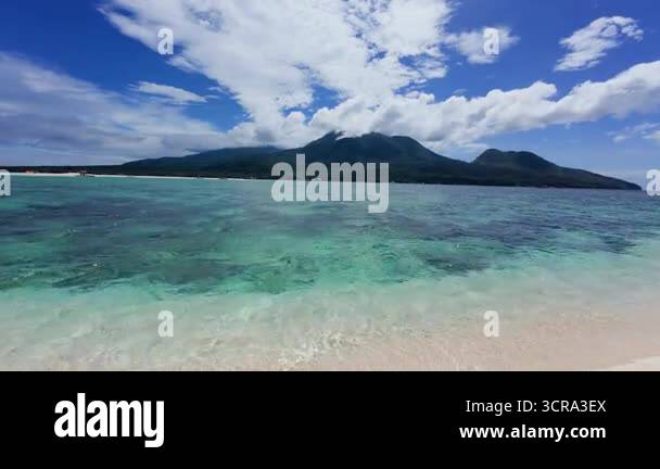 View overlooking blue clear tropical waters and volcanic island ...