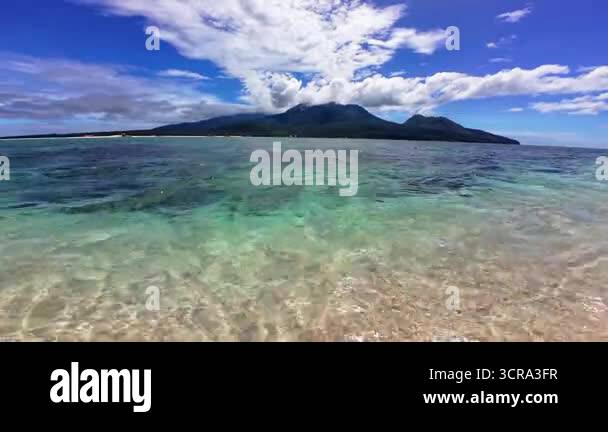 View overlooking blue clear tropical waters and volcanic island ...