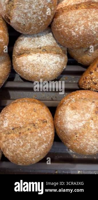 Close up video of rustic mixed bread rolls with flour dusting arranged ...