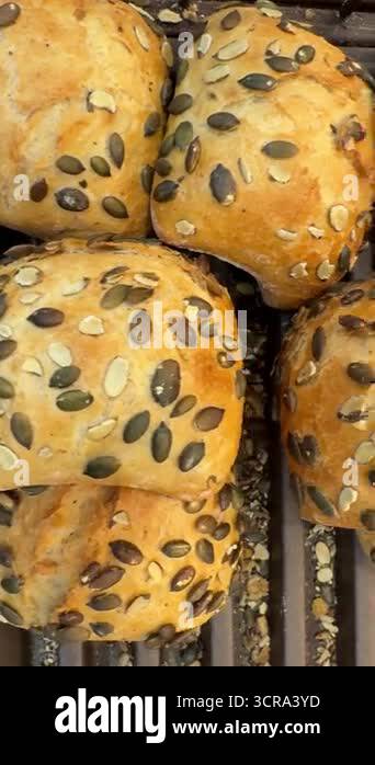 Video of pumpkin seed bread rolls freshly baked and displayed in bakery ...