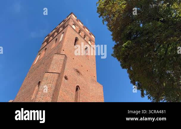 Video showing a low angle shot of a medieval brick gothic tower with ...