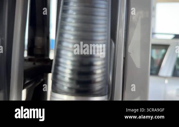 Video showing detailed closeup of ribbed fuel pump hose at gas station ...