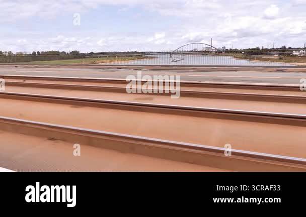 Wide shot of parallel rusty railway tracks stretching into the distance ...