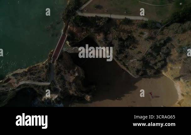Drone camera pulling out and slowly turning, while showing famous beach ...