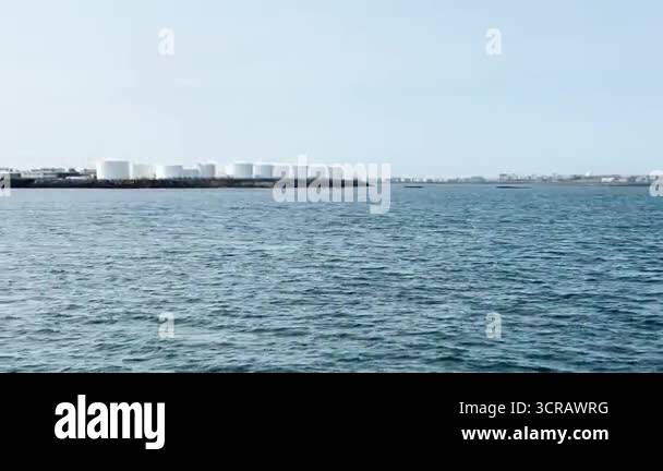 Seascape, view of huge white tanks, oil and fuel storage facilities ...
