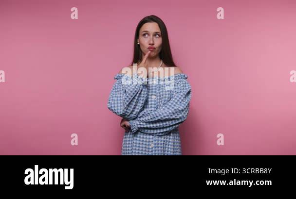 footage of young woman displays a pouty expression while playfully ...