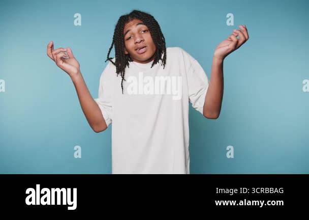 footage of young man with a questioning look stands, conveying ...