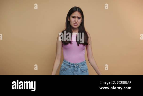 A girl with long hair strikes various expressive poses in front of a ...