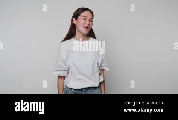 footage of young playful girl winks at the camera with a cheeky smile ...