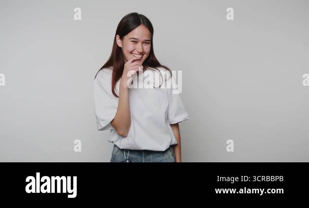 footage of young playful girl smiles while engaging in a quirky gesture ...