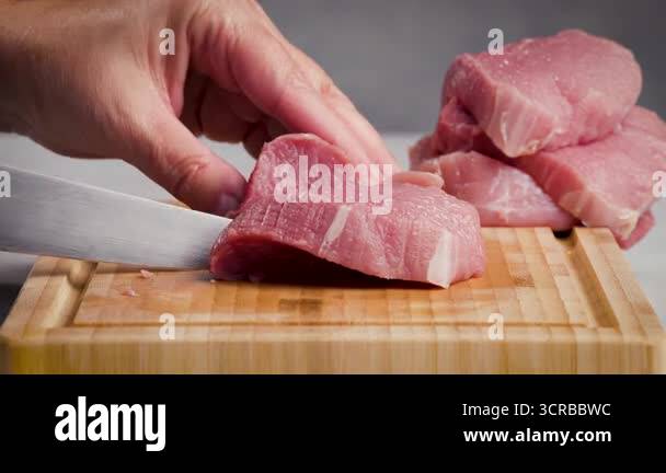 chef cut meat on cutting board with sharp knife for making healthy meal ...